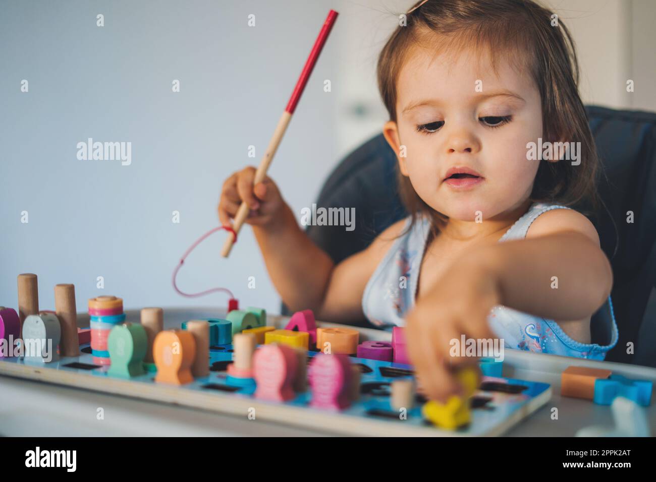 One year old baby girl playing, learning numbers, count with help of a ...