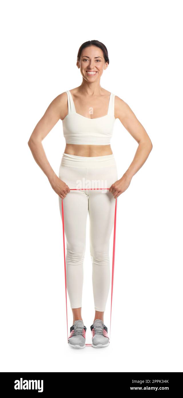 Woman doing sportive exercise with fitness elastic band on white ...