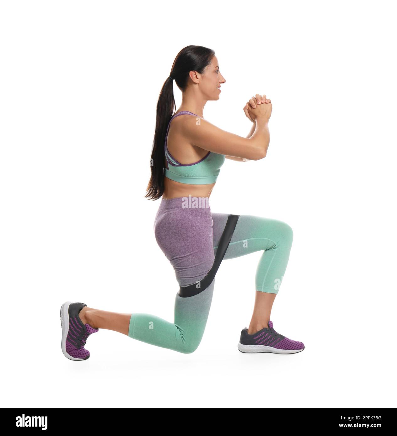 Woman doing sportive exercise with fitness elastic band on white ...