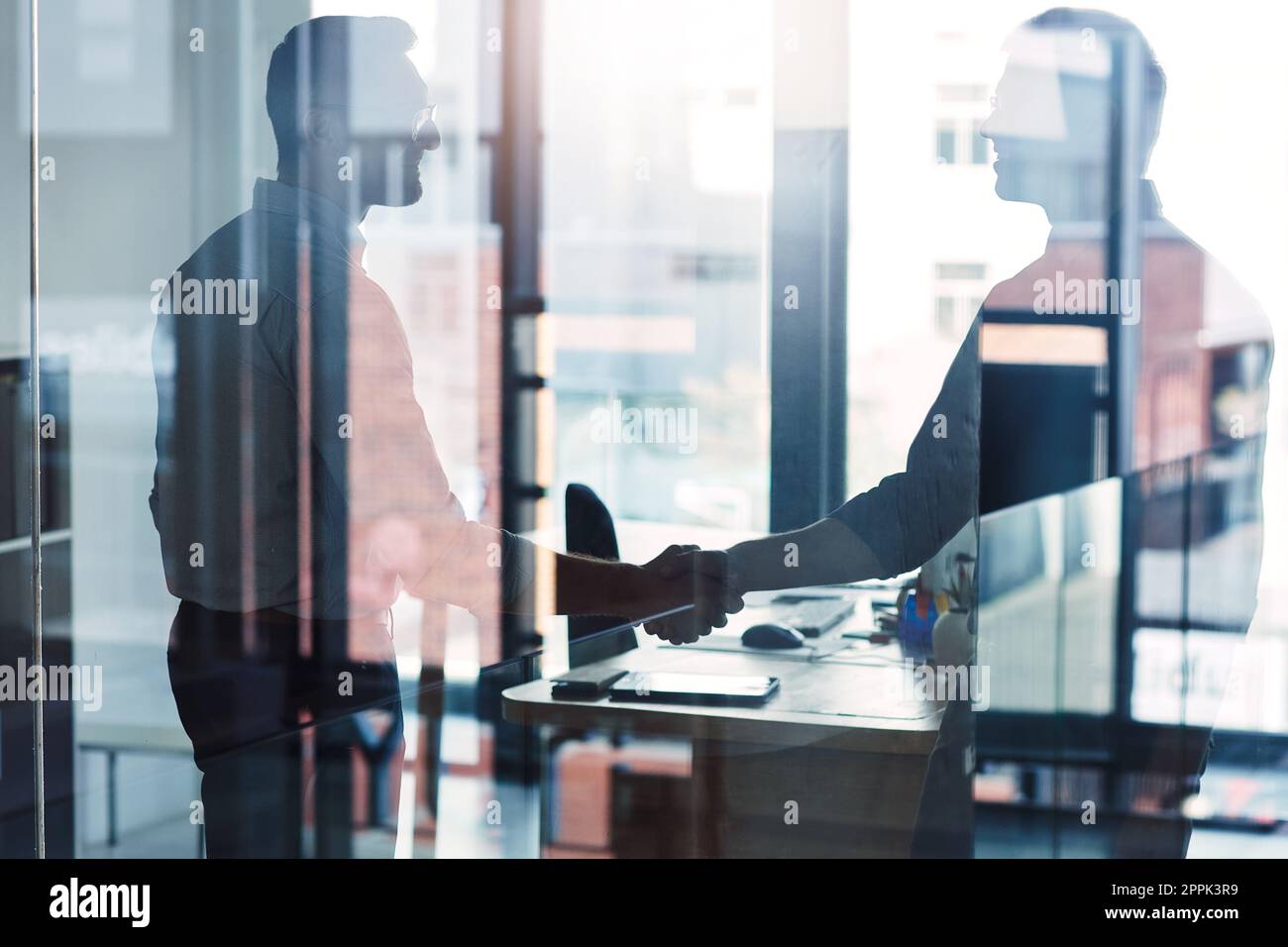 Lets join forces and claim greater successes. two businessmen shaking ...