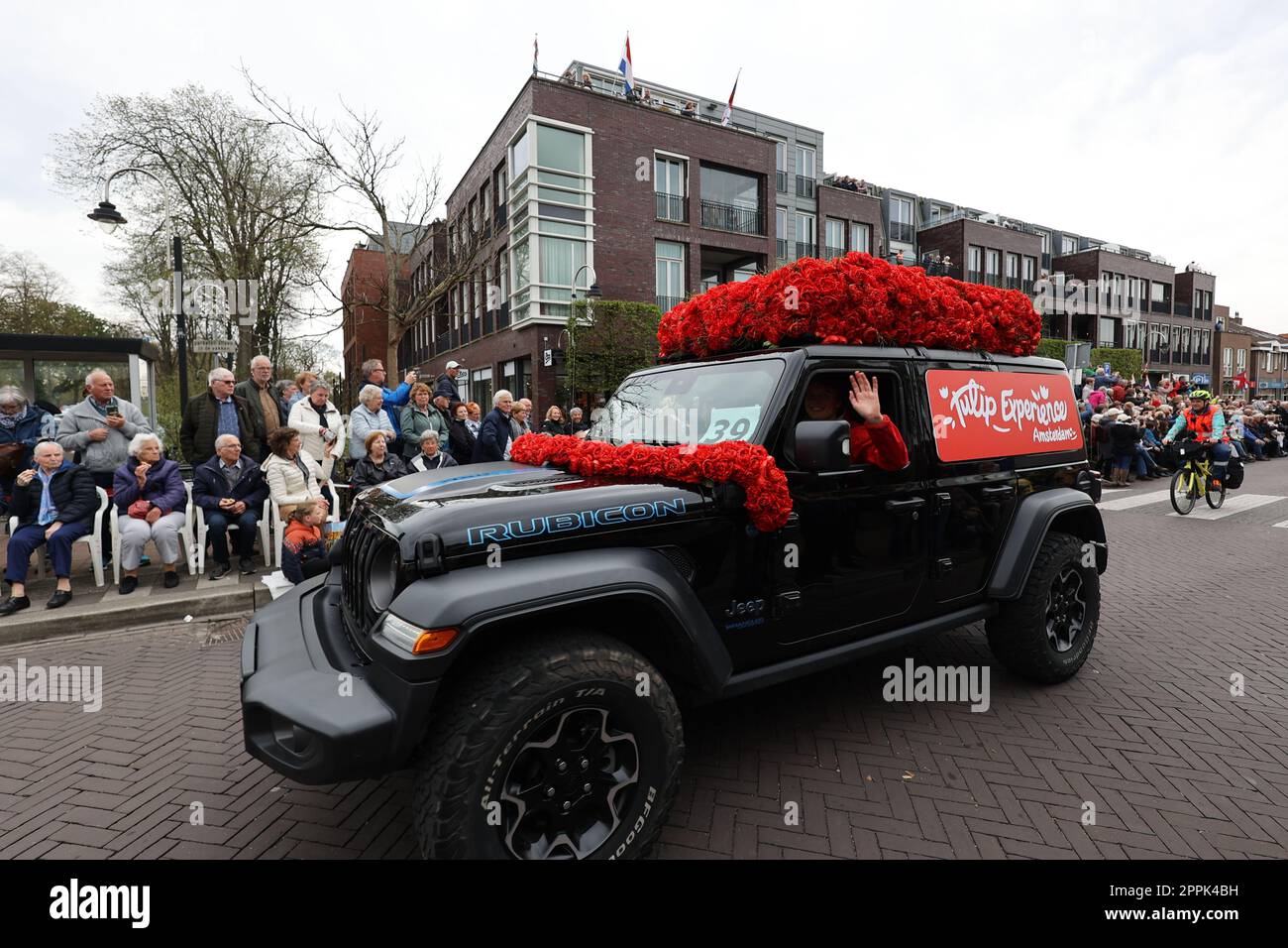 A jeep adorned with colorful floral arrangements at the Flower Parade ...