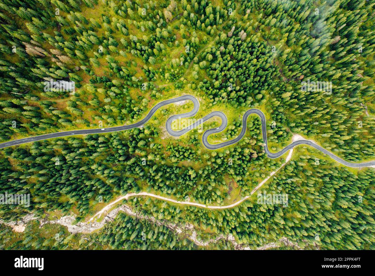Aerial view of Snake road passing through the green forest Stock Photo ...