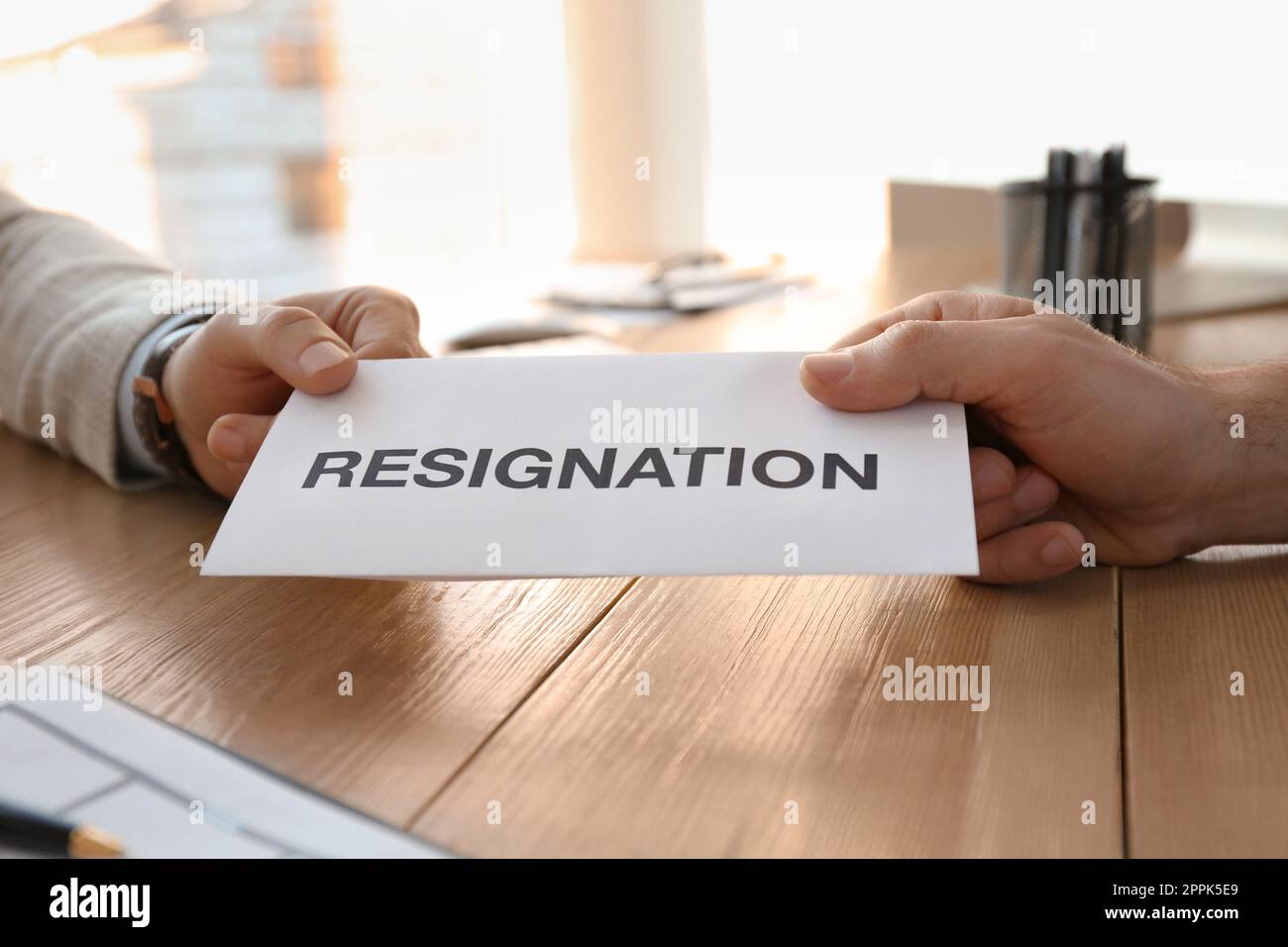 Employee giving resignation letter to boss in office, closeup Stock ...