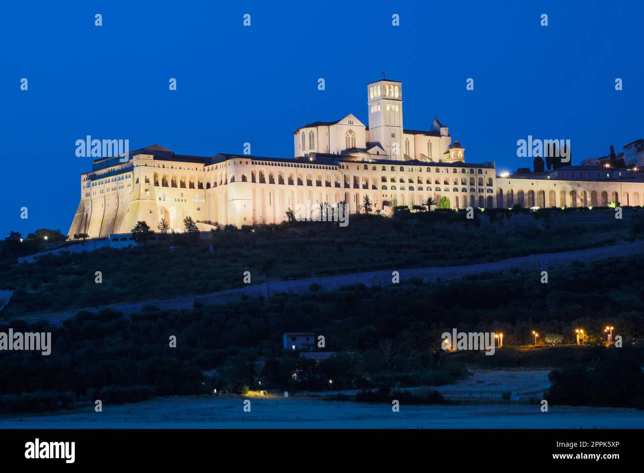 Assisi Basilica by night, Umbria region, Italy. The town is famous for ...