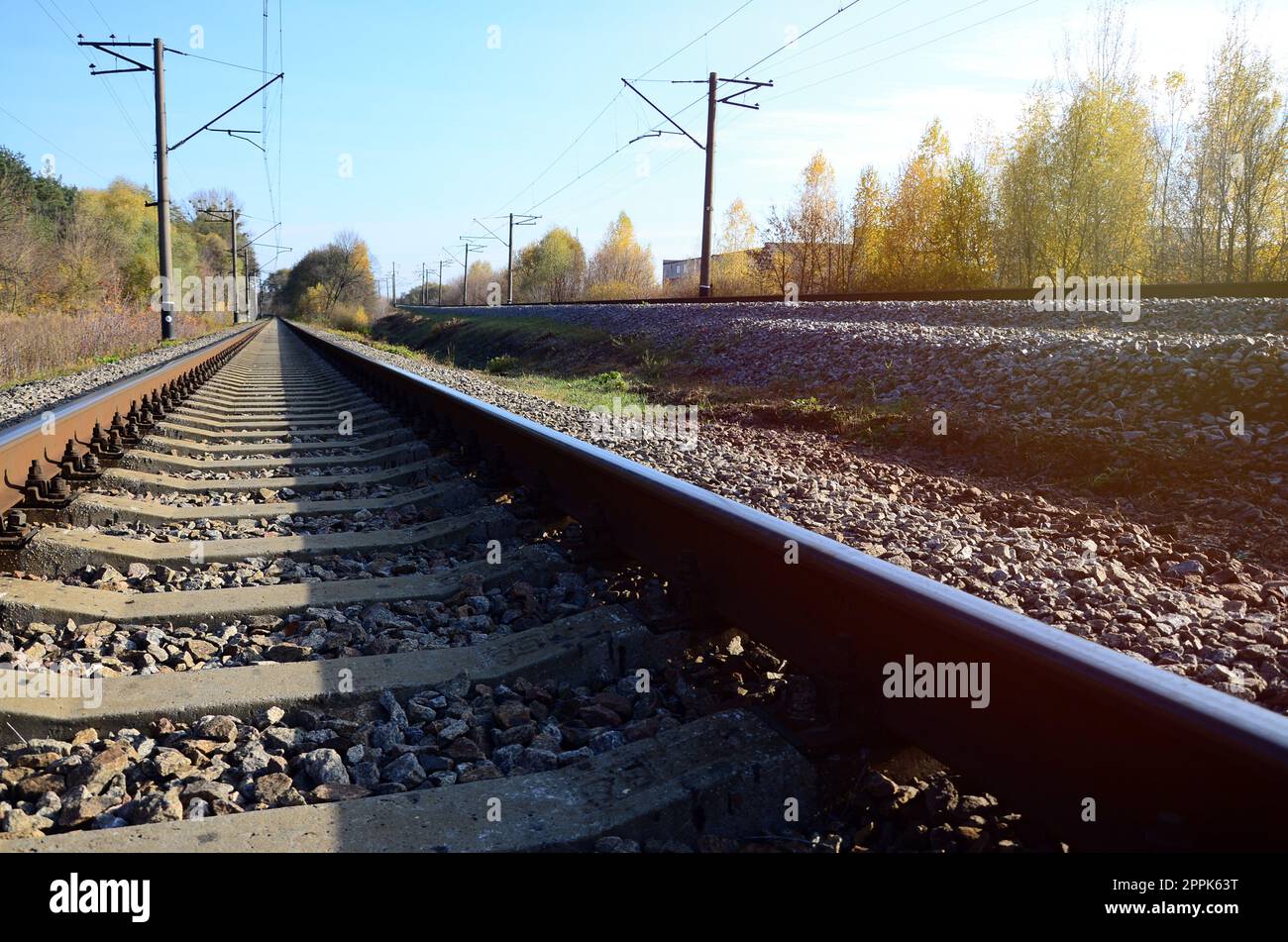 Autumn industrial landscape. Railway receding into the distance among ...