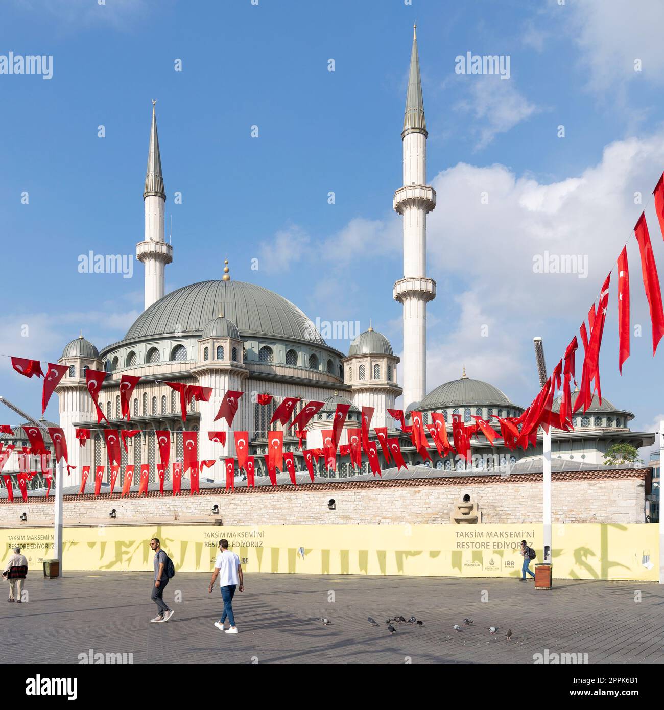 Few pedestrians walking in front of Taksim Mosque, at Taksim Square ...
