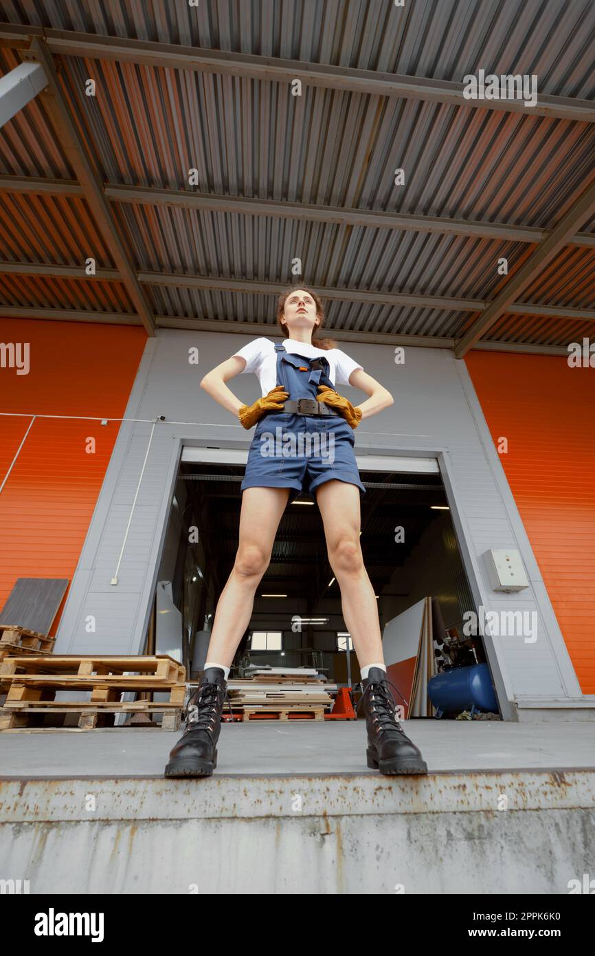 Low angle view at female worker in uniform standing on ramp Stock Photo ...