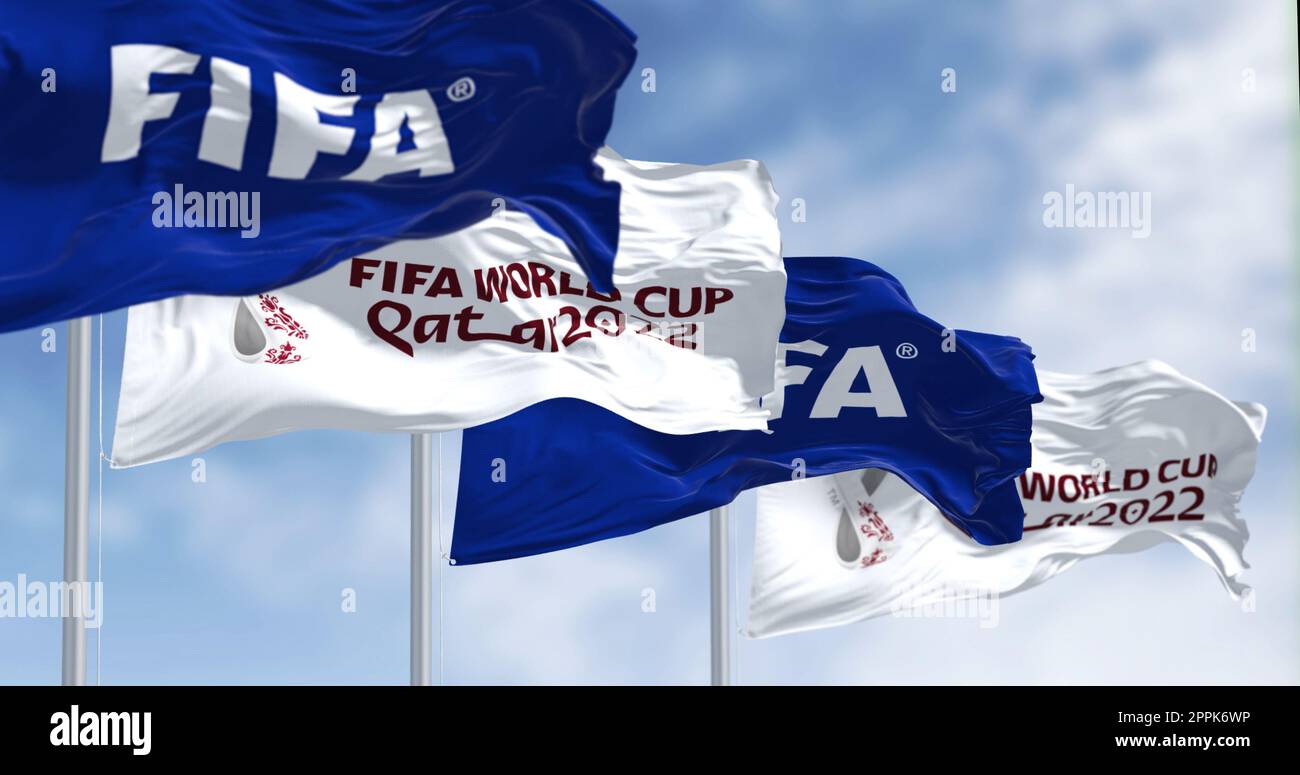 Flags with FIFA and Qatar 2022 World Cup logo waving in the wind Stock ...