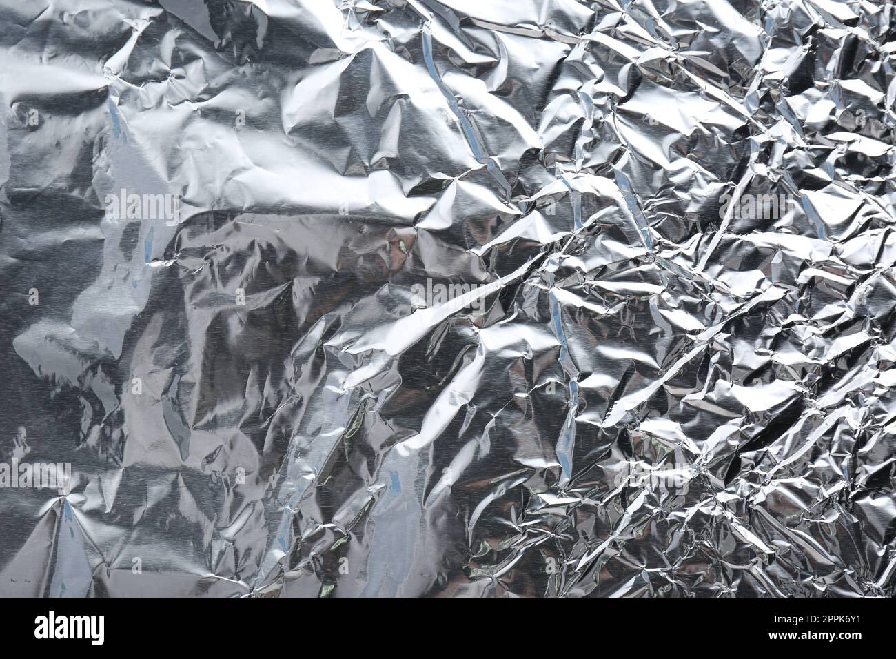 Crumpled silver foil as background, closeup view Stock Photo - Alamy