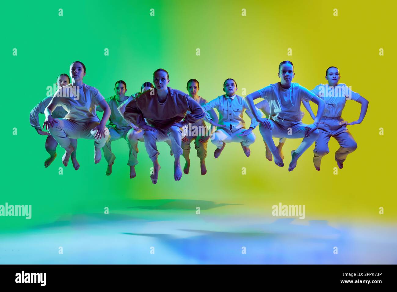 Portrait with group of teenagers, young dancers jumping up together ...