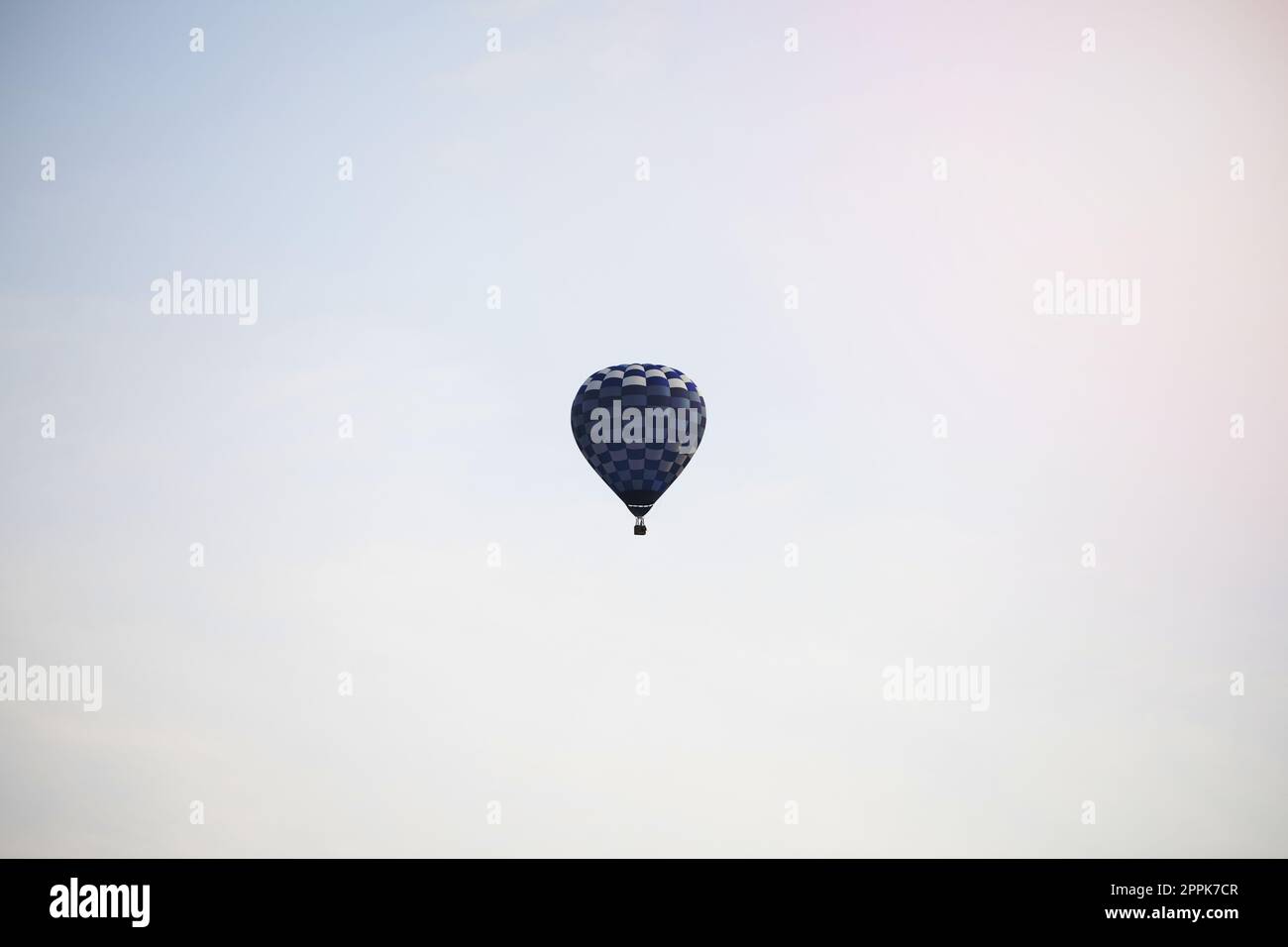 Blue hot air balloon flying in the sky Stock Photo - Alamy