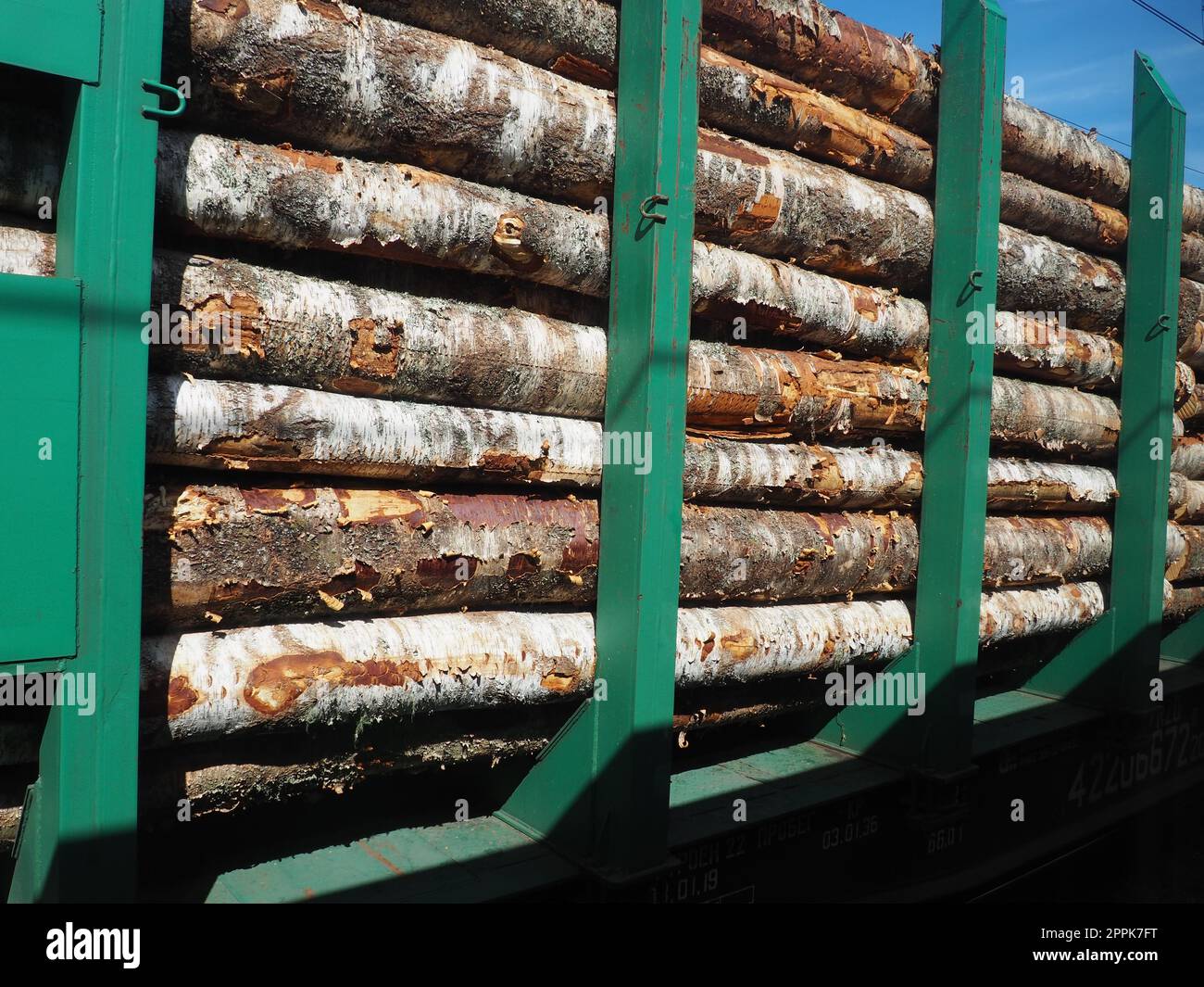 cargo timber train. Open train carriage with a bundle of timber for ...