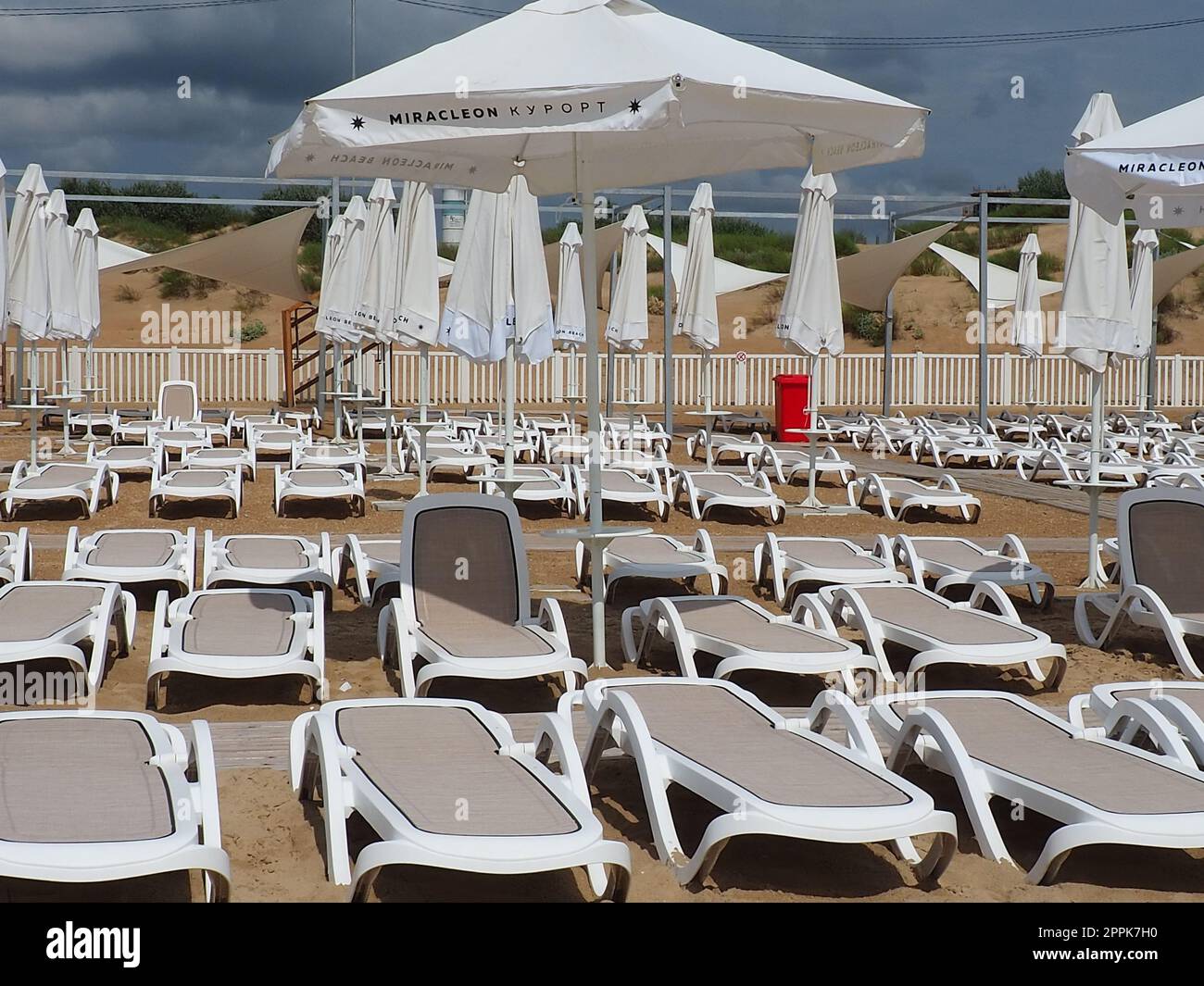 Anapa, Russia, August 15, 2021 Wet sunbeds and umbrellas on the sea ...