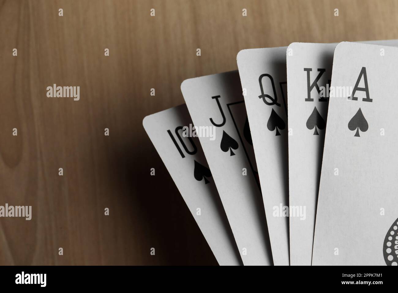 Playing cards with royal flush combination, closeup. Space for text ...