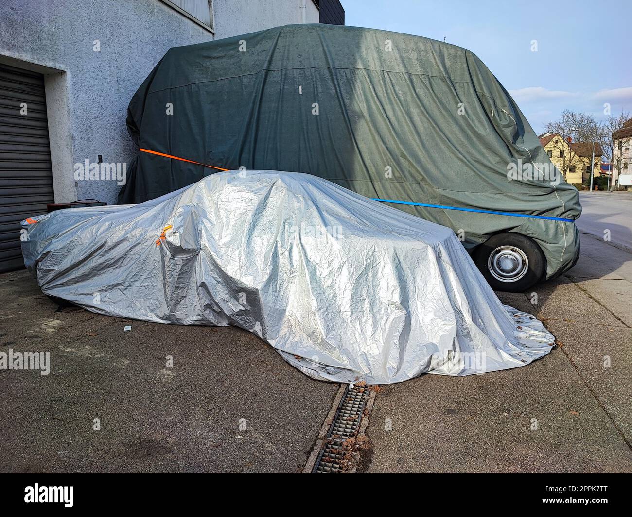 camper and car in a parking lot covered with a protective covering ...