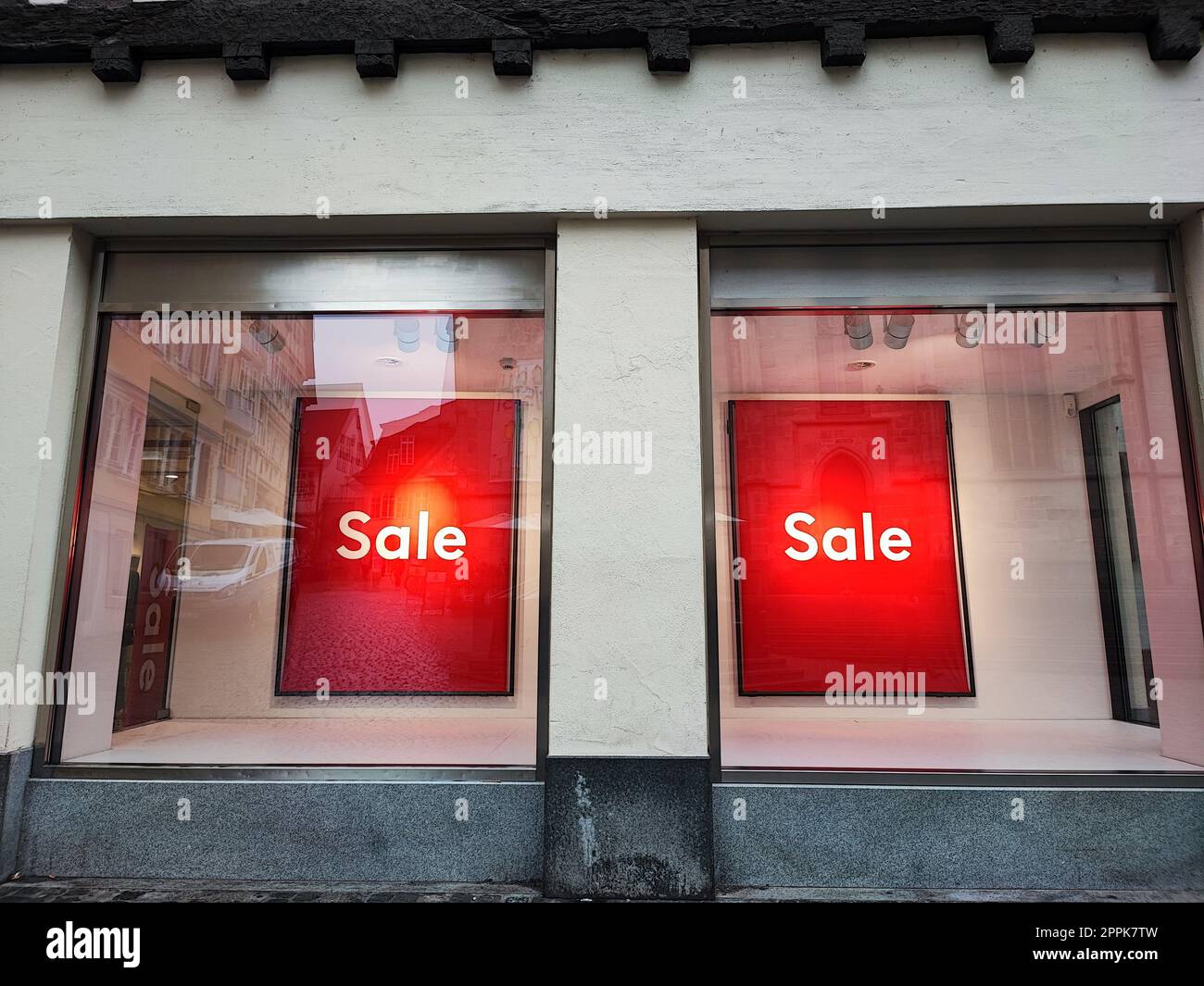sale posters in a window of a shop in the city Stock Photo - Alamy