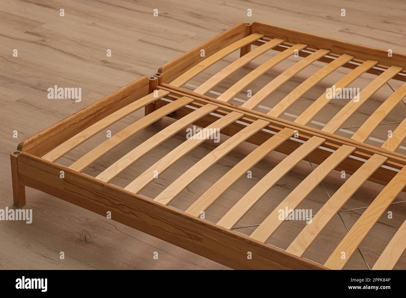 Wooden bed frame on floor, closeup view Stock Photo - Alamy
