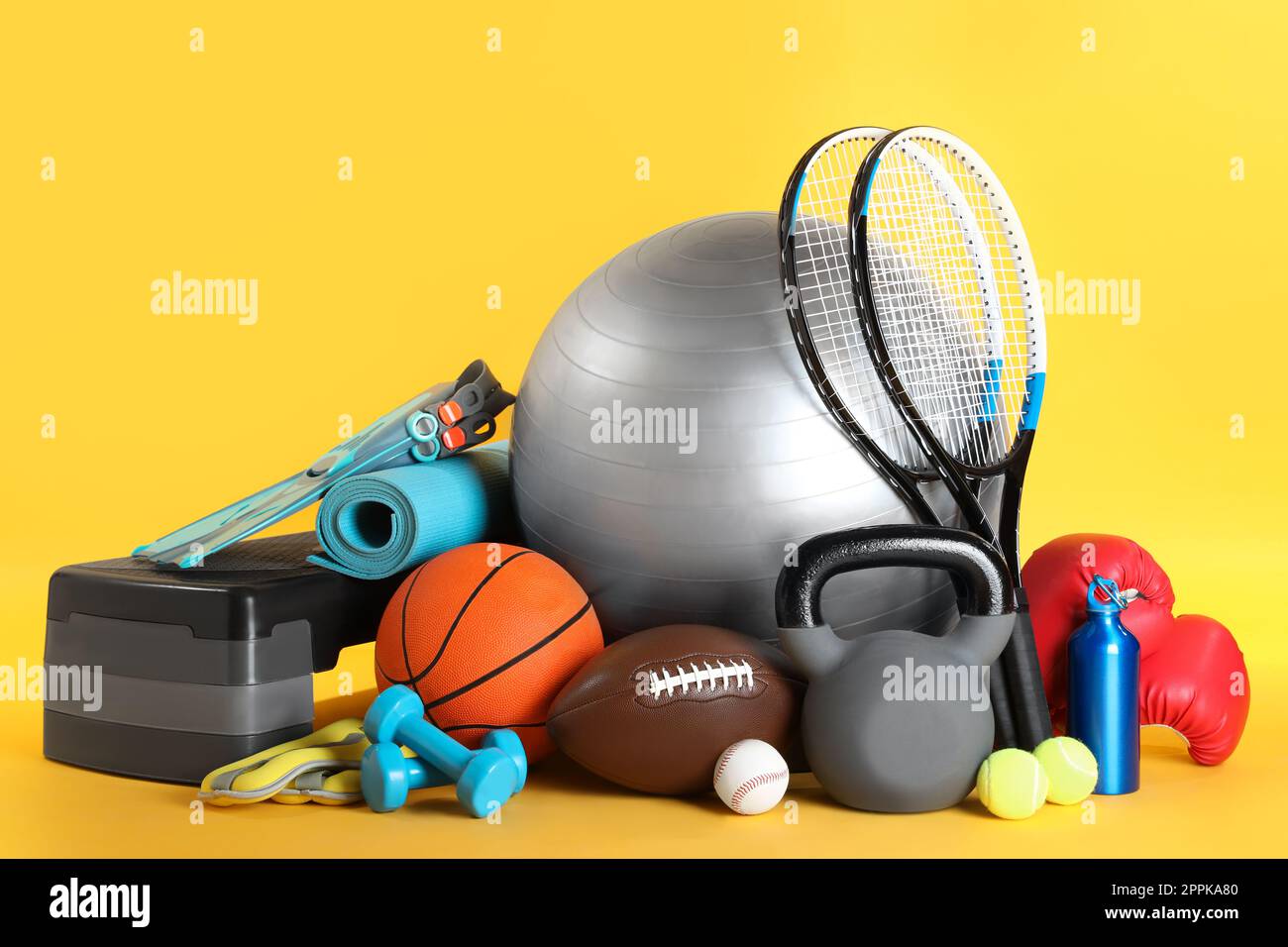 Set of different sports equipment on yellow background Stock Photo - Alamy