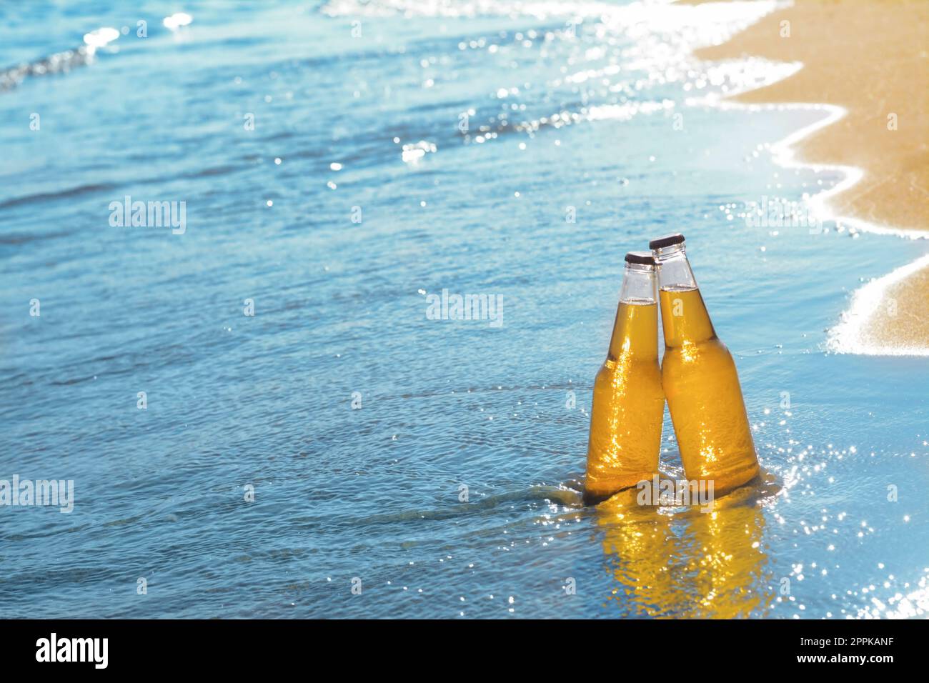 Bottles of cold beer in sea water, space for text Stock Photo - Alamy