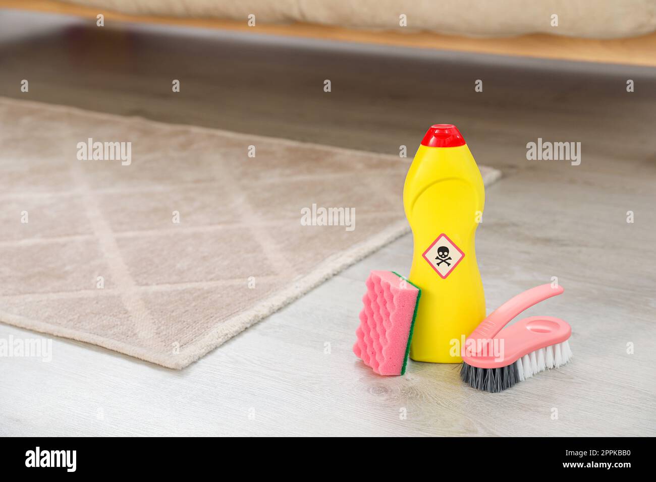 Bottle of toxic household chemical with warning sign, brush and ...