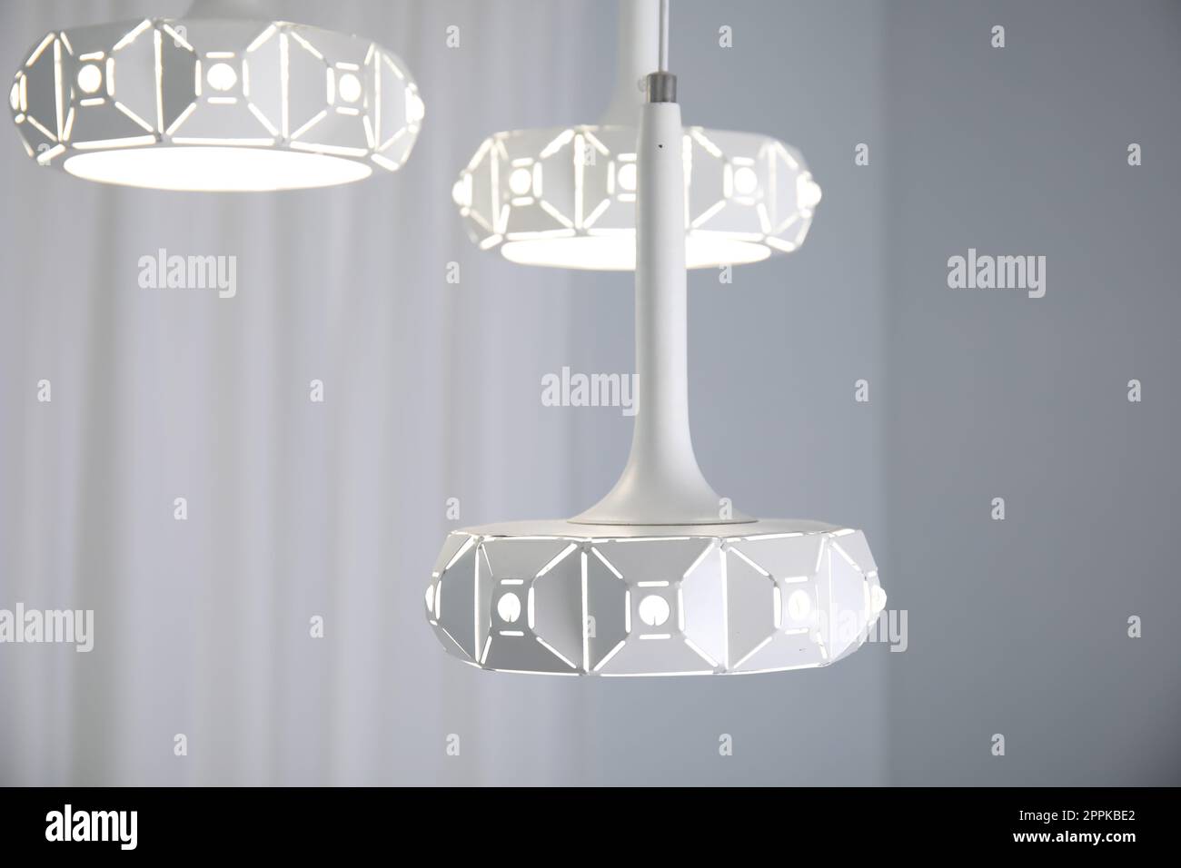 Stylish white pendant lamp in light room Stock Photo - Alamy