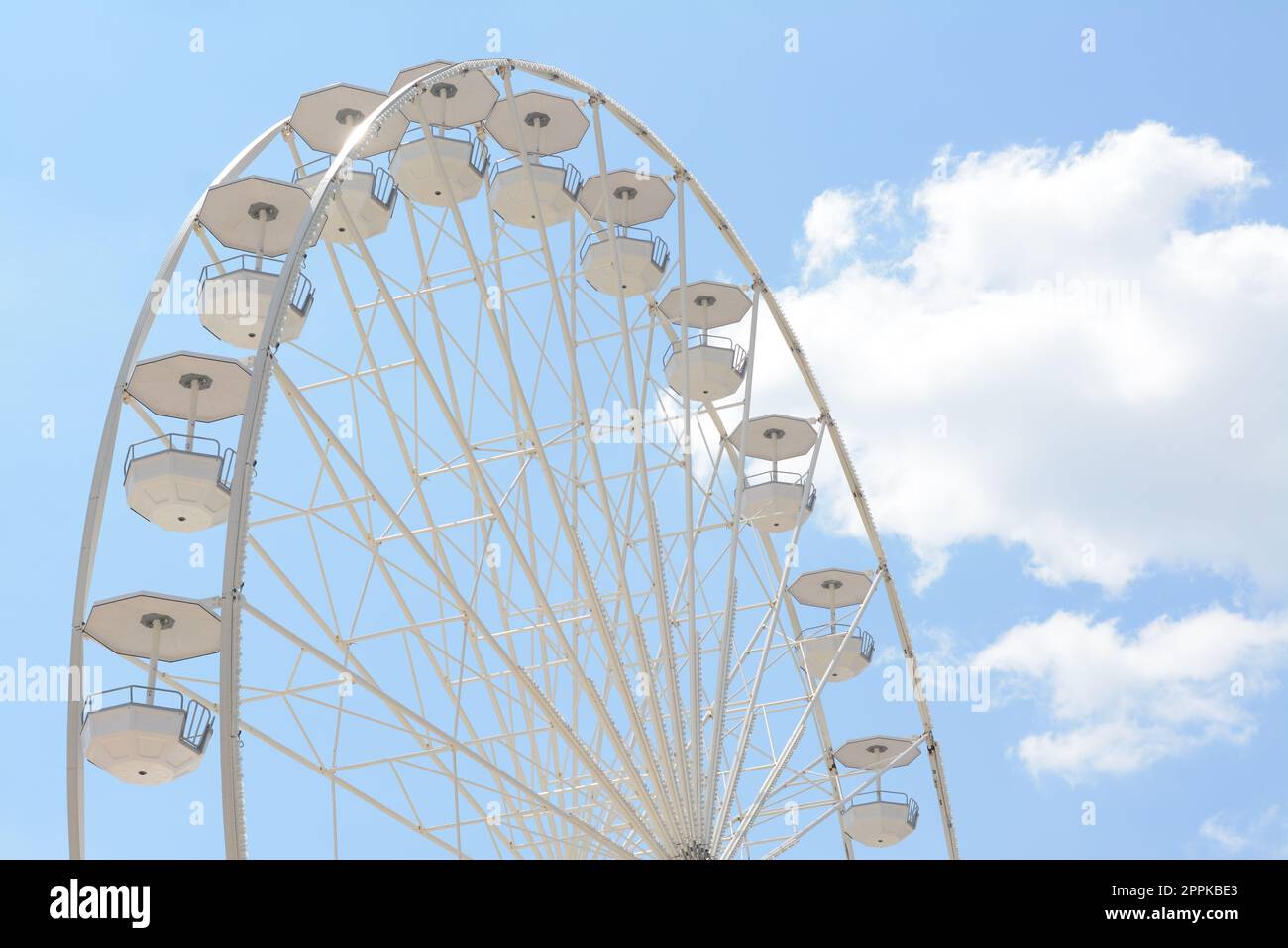 Large white observation wheel against blue cloudy sky Stock Photo - Alamy