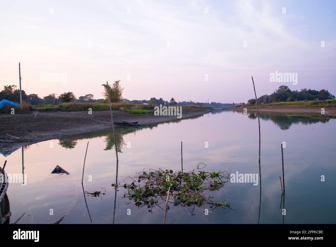 Arial View Canal with green grass and vegetation reflected in the water ...