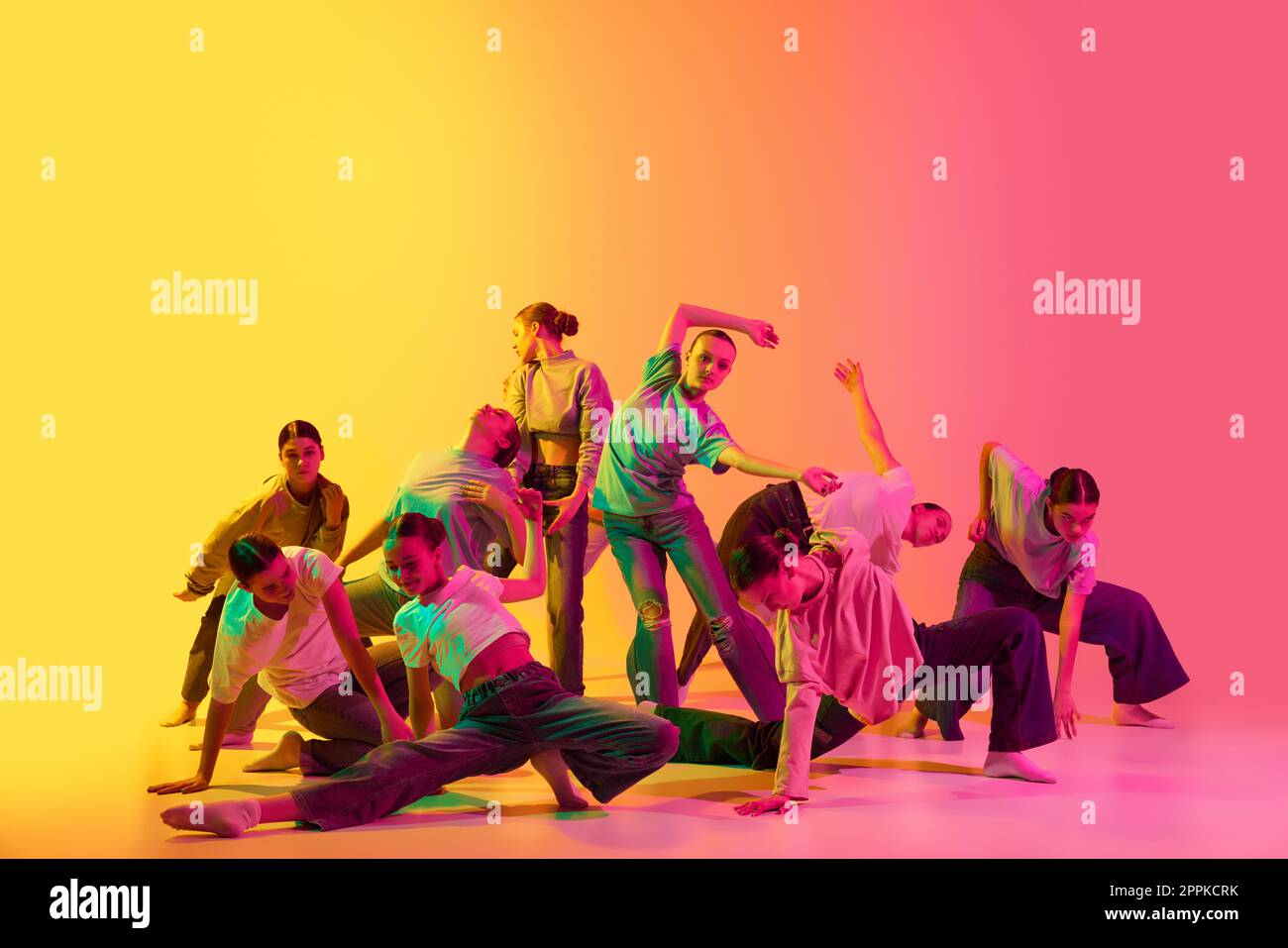 Group of young charming girls, dancers moving to the beat of the music ...