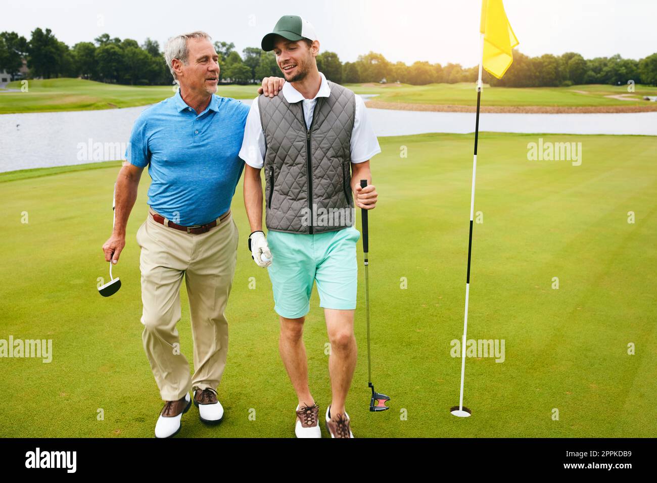 Mixing a little business with pleasure. two friends out playing golf ...