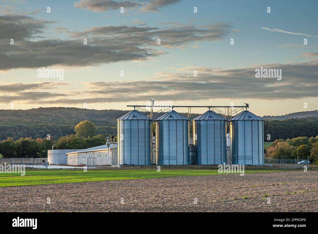 agricultural silos in sunset with beautiful sky Stock Photo - Alamy