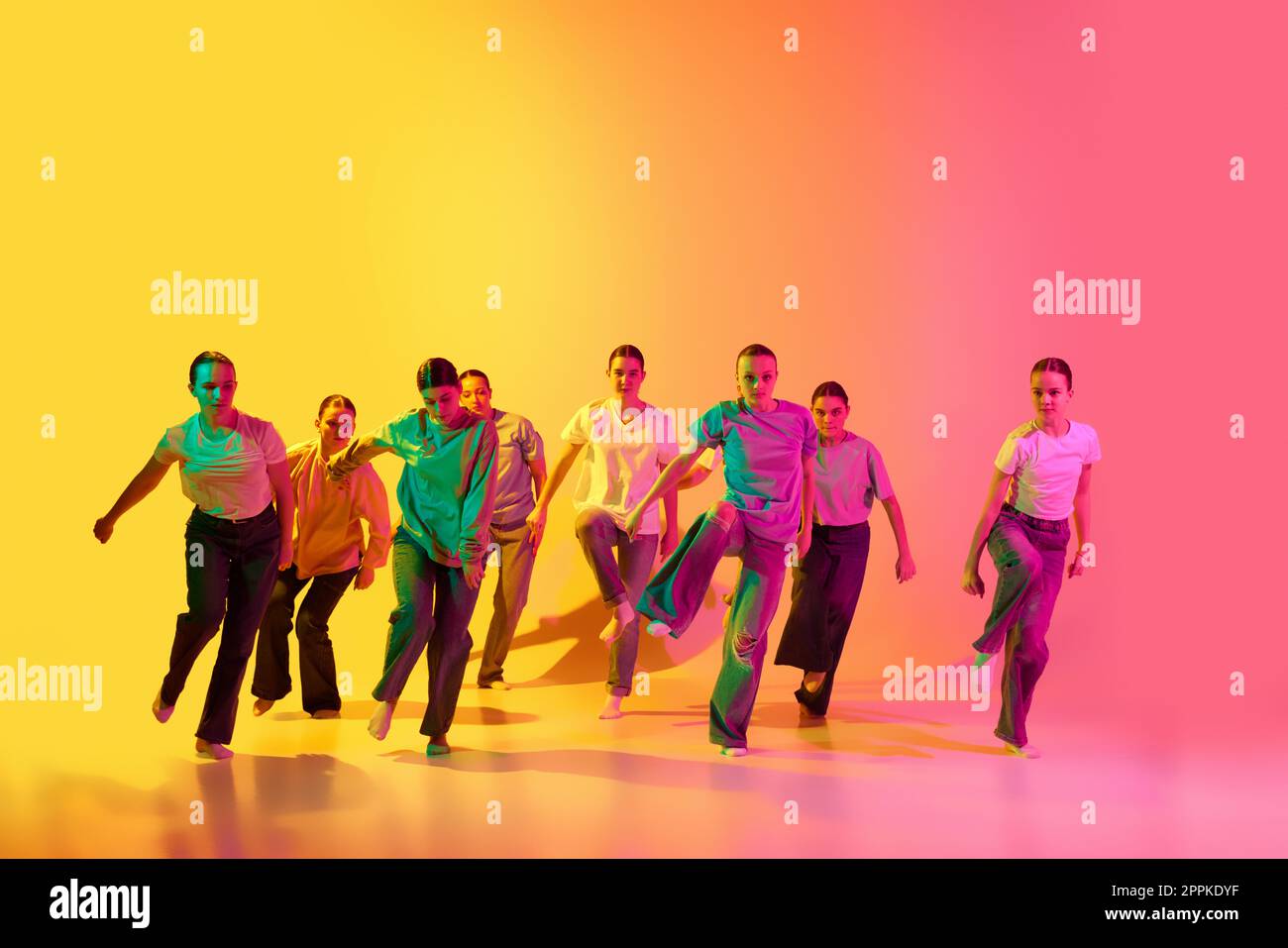 Portrait with group of teenagers, young dancers jumping together over ...