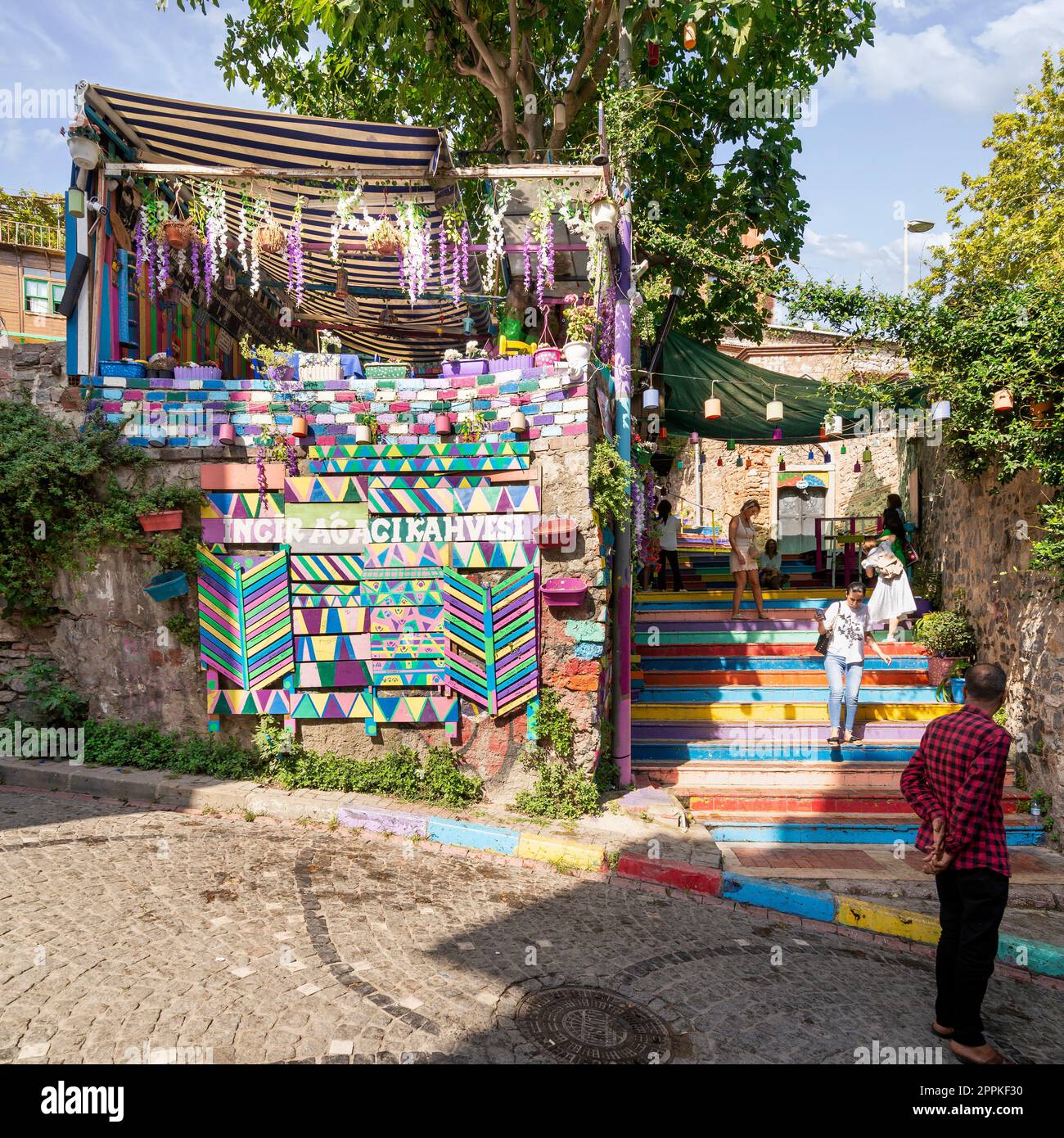 Tourists at traditional cafe decorated with multicolored panels and ...