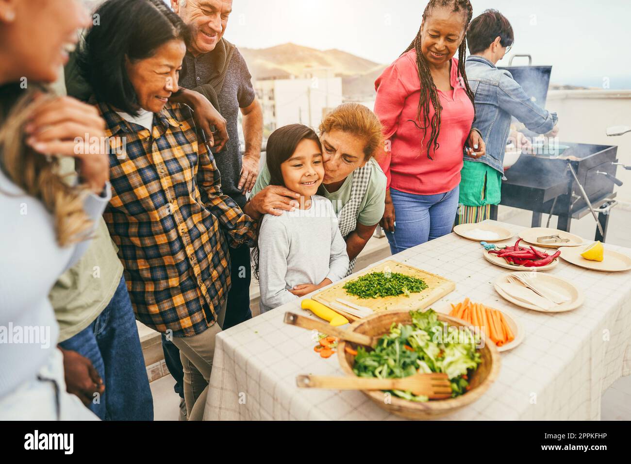 Multi generational people doing barbecue at home's rooftop ...