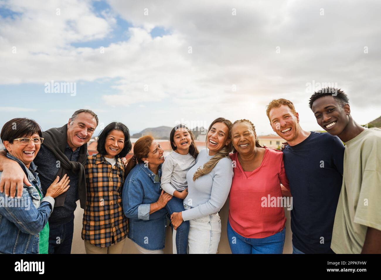 Group of multigenerational friends smiling in front of camera ...