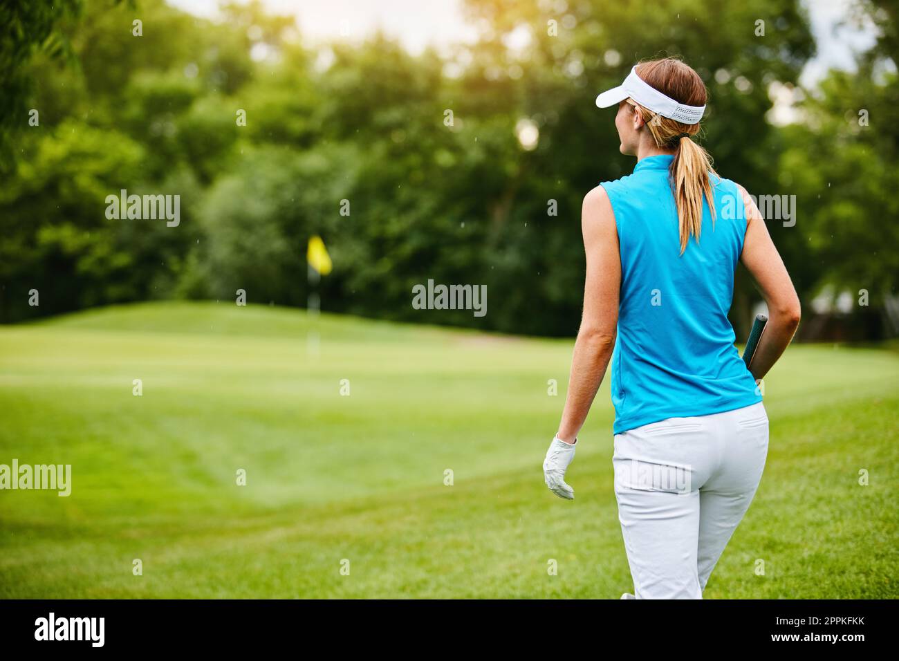 Happiness is a long walk with the putter. a woman on a golf course ...