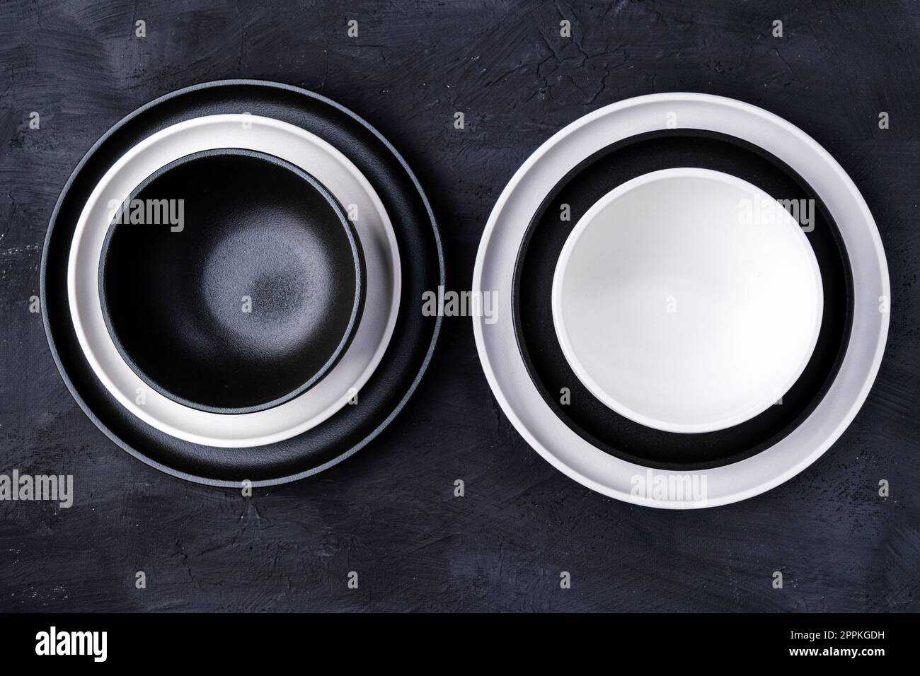 Empty ceramic plate, black and white on a concrete white background ...