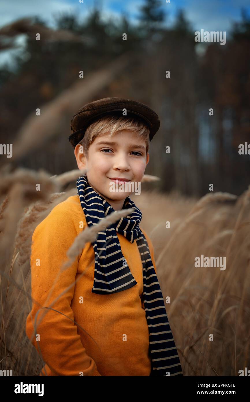 Children's fashion, retro style. A smiling little boy in a retro style ...