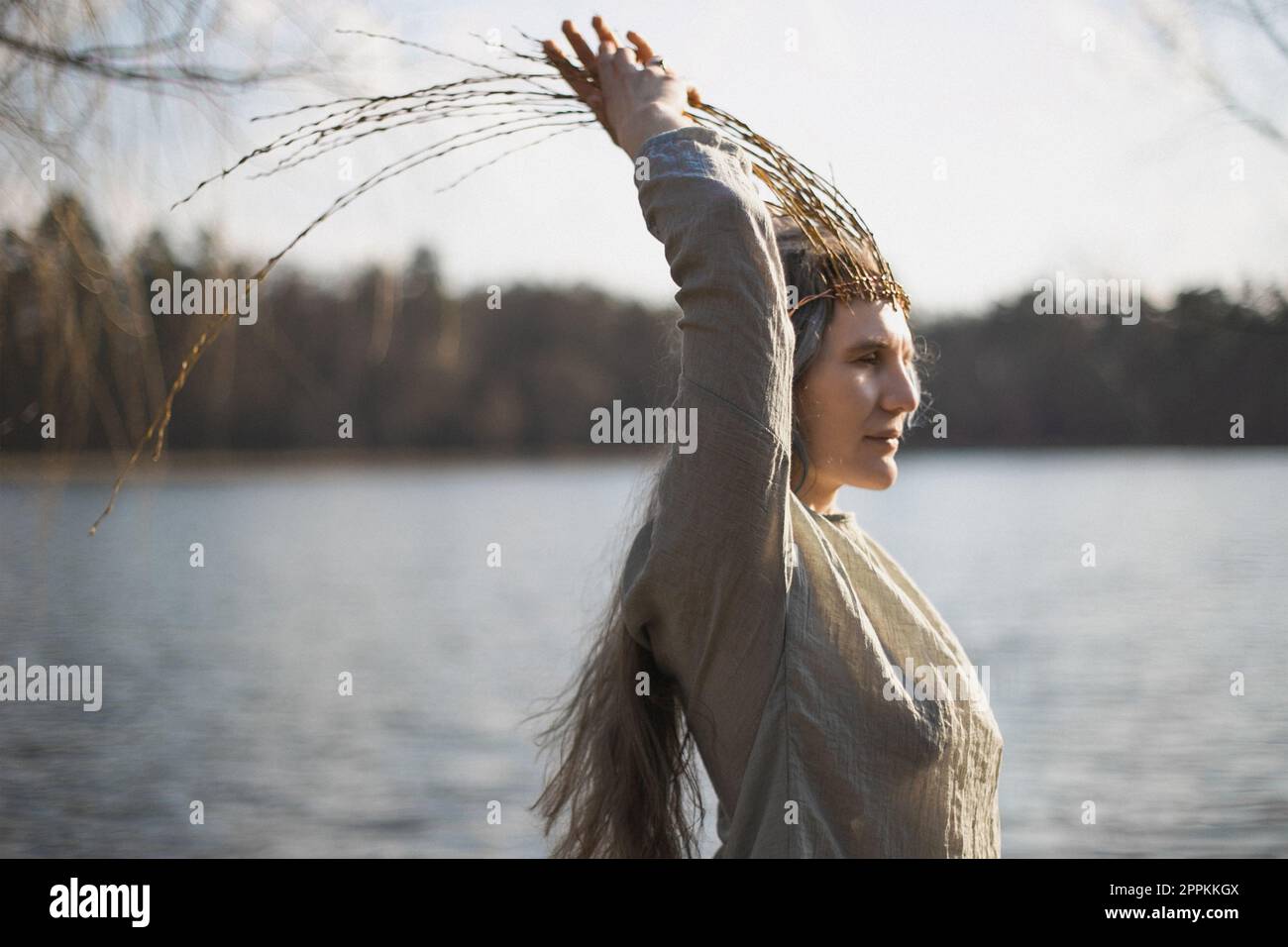 Close up authentic woman running hand up willow twigs crown portrait ...