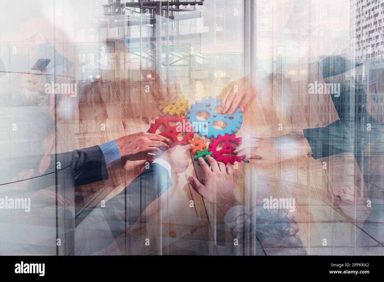 Business team connect pieces of colorful gears like a teamwork and ...