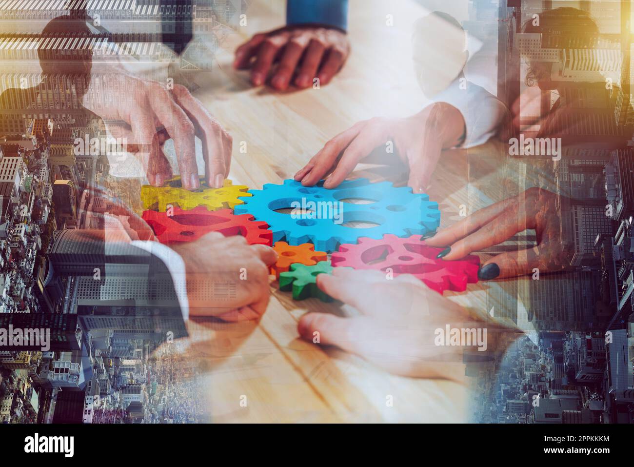 Business team connect pieces of colorful gears like a teamwork and ...