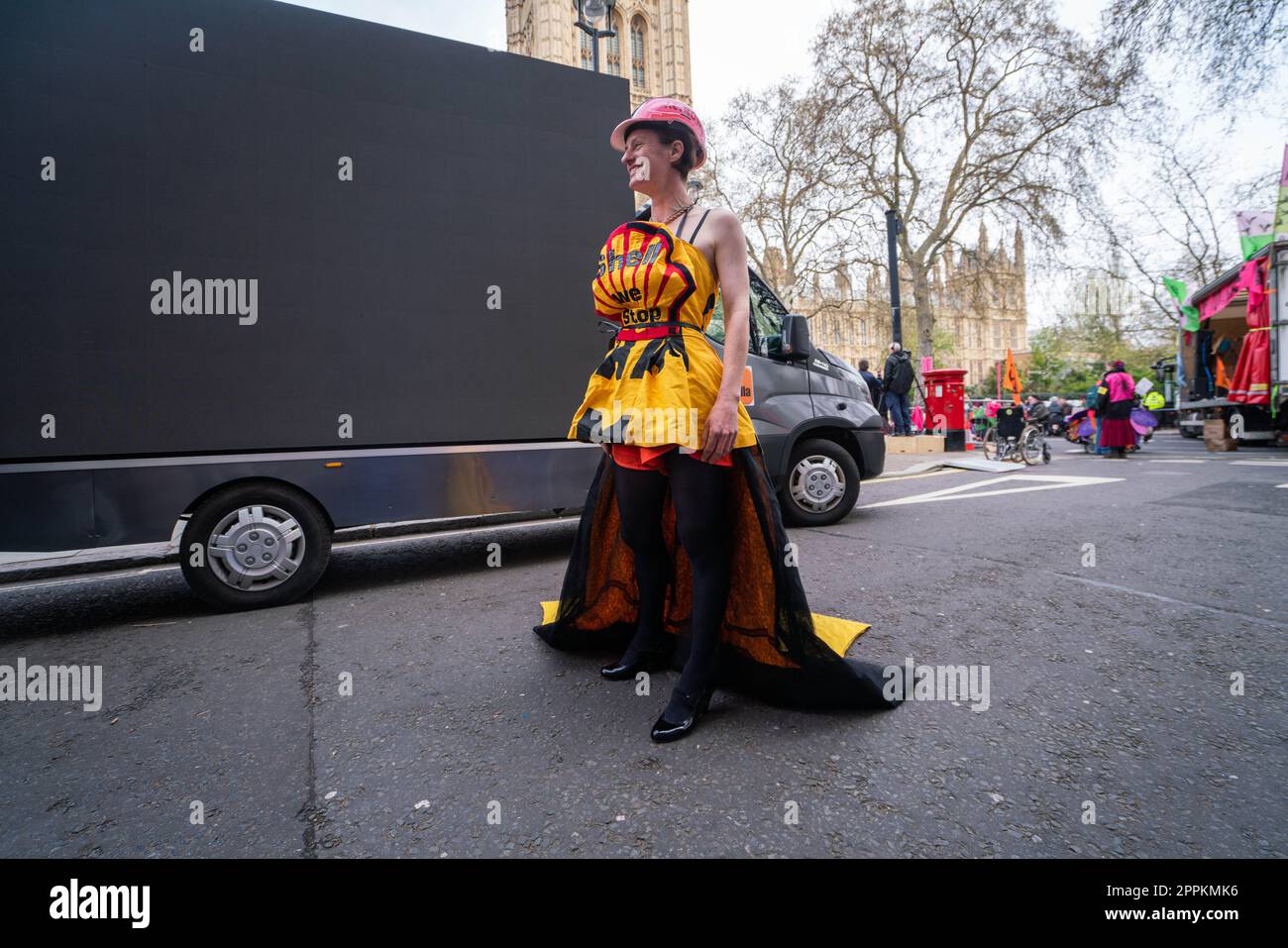 London UK. 24 April 2023. A climate activist wears a dress with a Shell ...