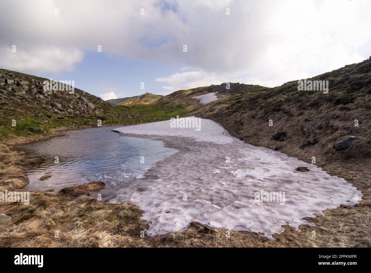 Melting ice puddle in spring mountains landscape photo Stock Photo - Alamy