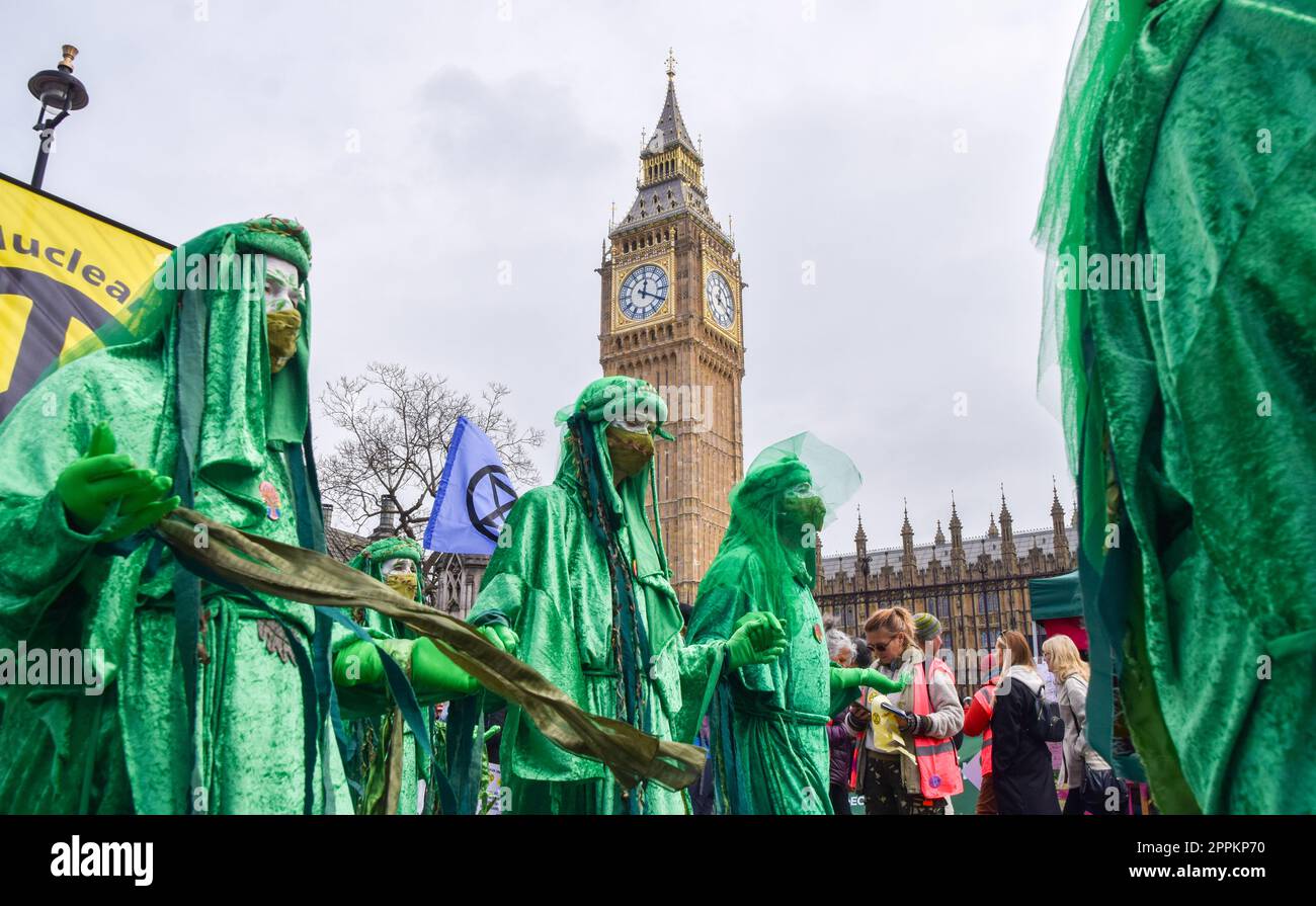 London, UK. 24th April 2023. The Green Spirits walk past Big Ben in ...