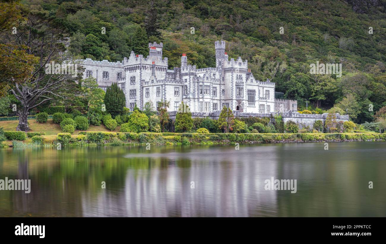 Kylemore Abbey, beautiful white castle with blurred reflection in lake ...