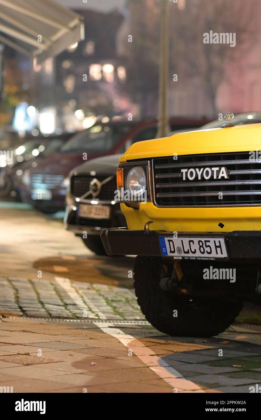 Front view with details of a parked old yellow Toyota Landcruiser in ...