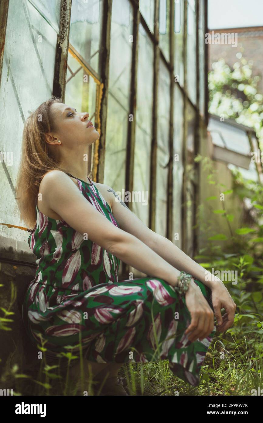 Leaning against window tiredly scenic photography Stock Photo - Alamy