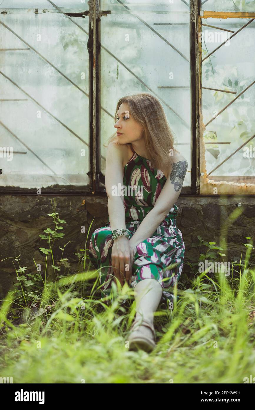 Leaning against tall window and looking away scenic photography Stock ...