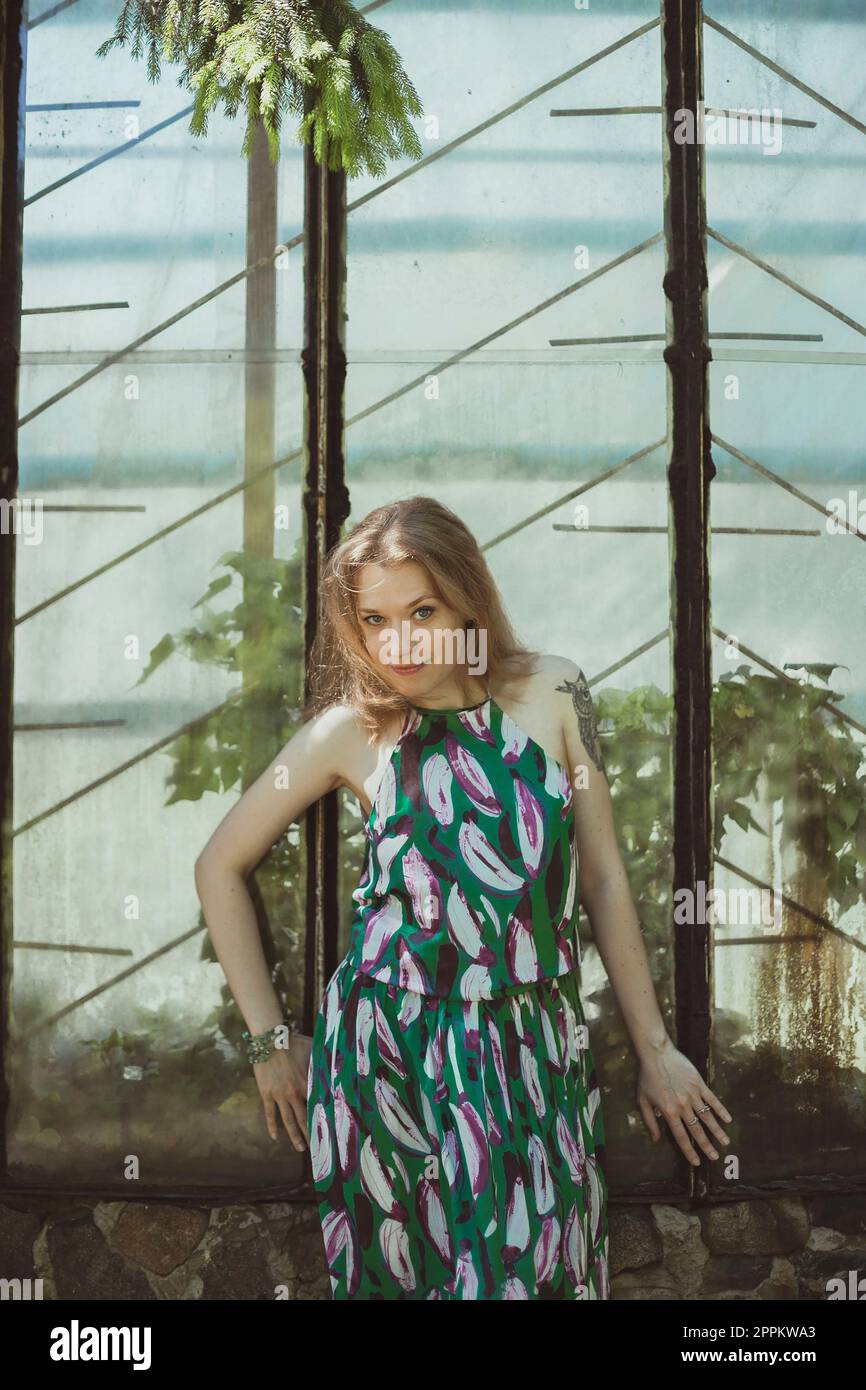 Young woman in dress posing with awkward smile scenic photography Stock ...
