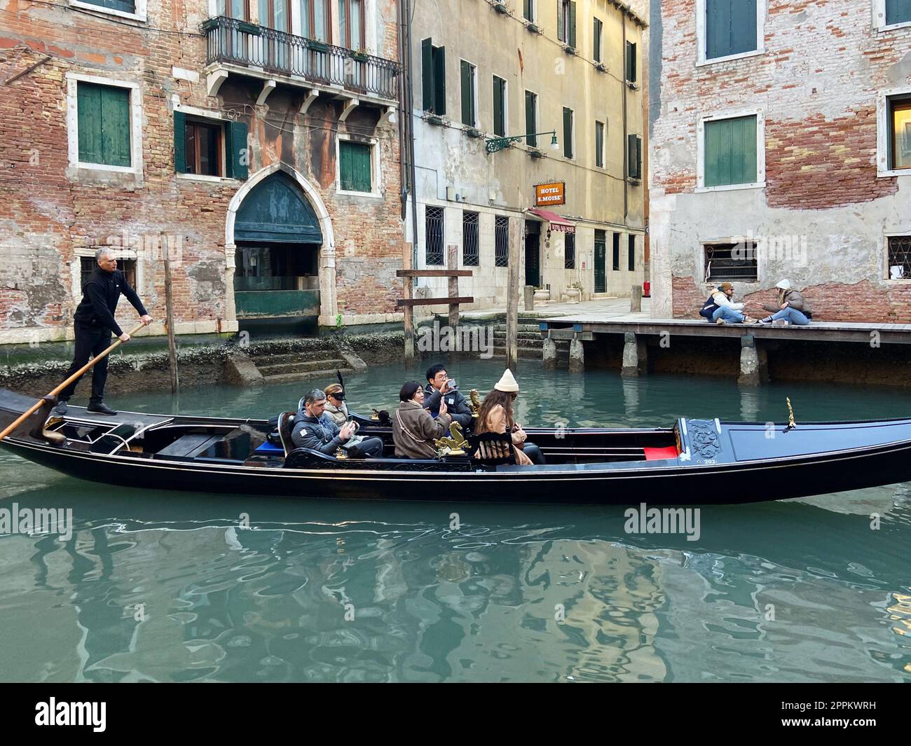 gondola with tourists floats along canal in Venice Stock Photo - Alamy