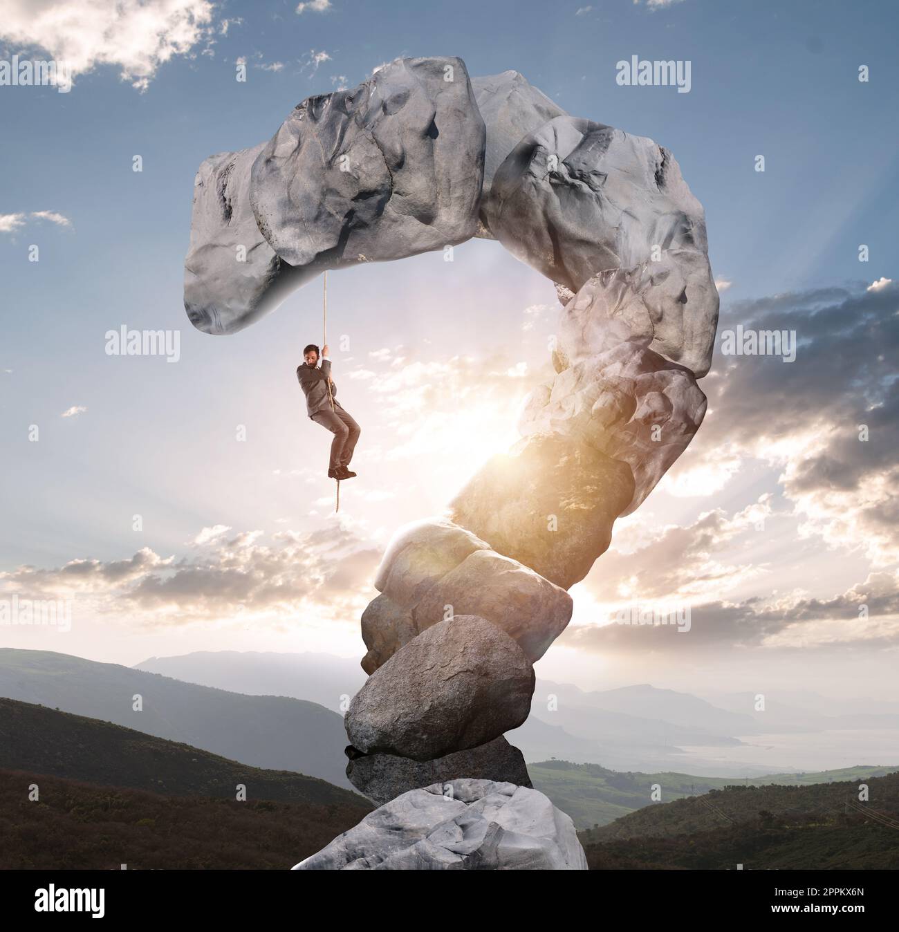 Businessman tries to climb with difficulty on a mountain shaped as ...